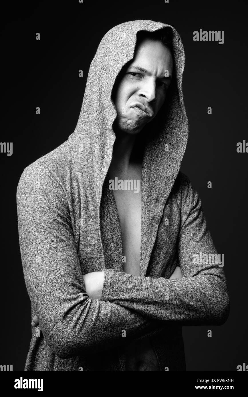 Rebellious man against black background in black and white Stock Photo ...