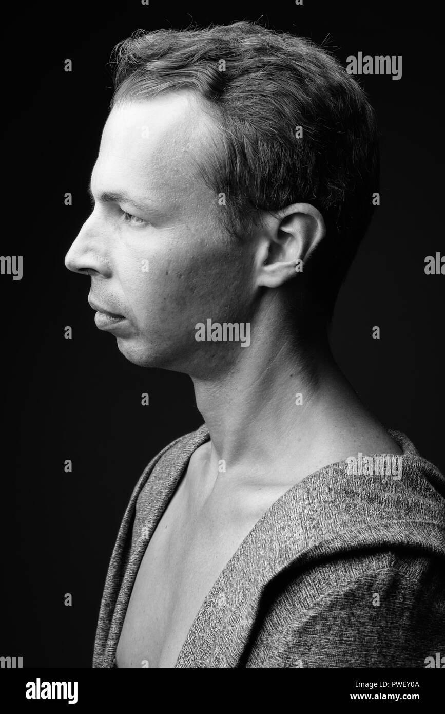 Rebellious man against black background in black and white Stock Photo ...