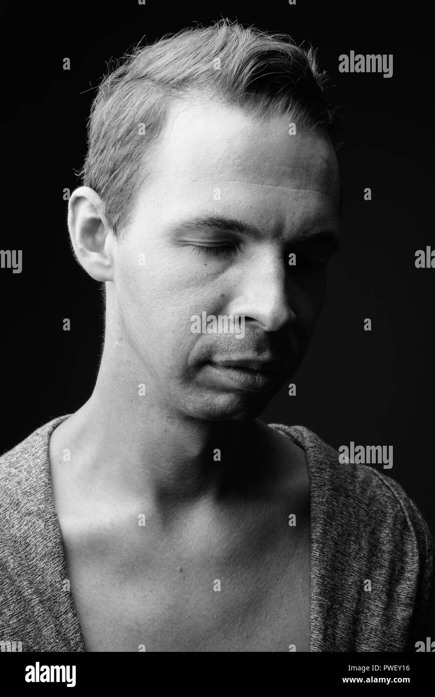 Rebellious man against black background in black and white Stock Photo ...