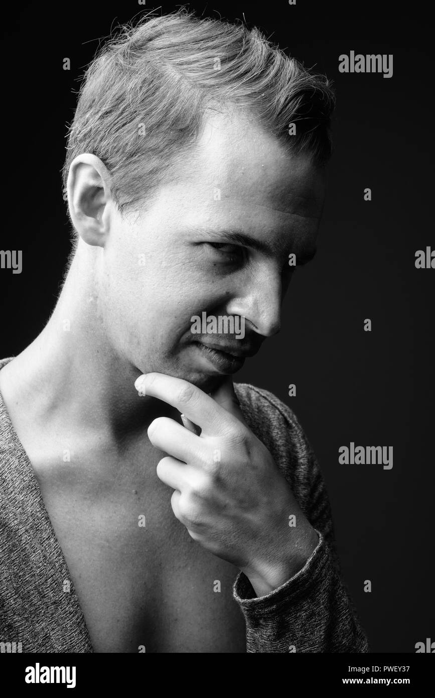 Rebellious man against black background in black and white Stock Photo ...