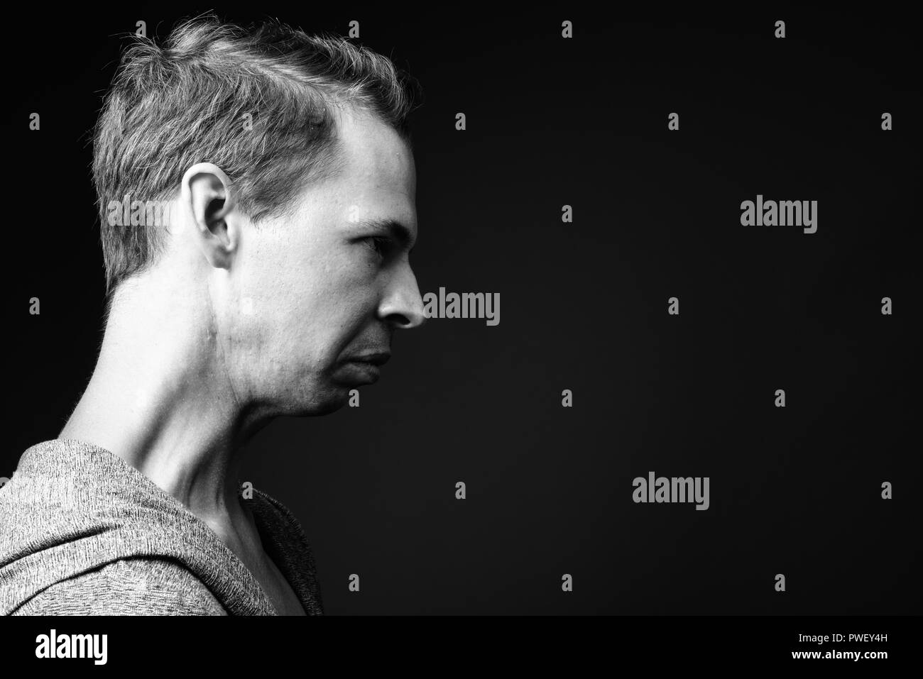 Rebellious man against black background in black and white Stock Photo ...