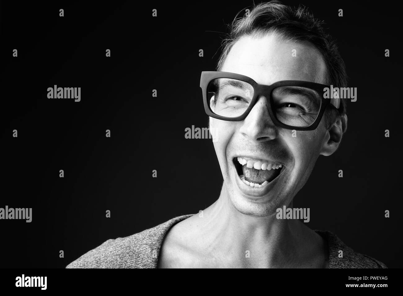 Rebellious man against black background in black and white Stock Photo ...