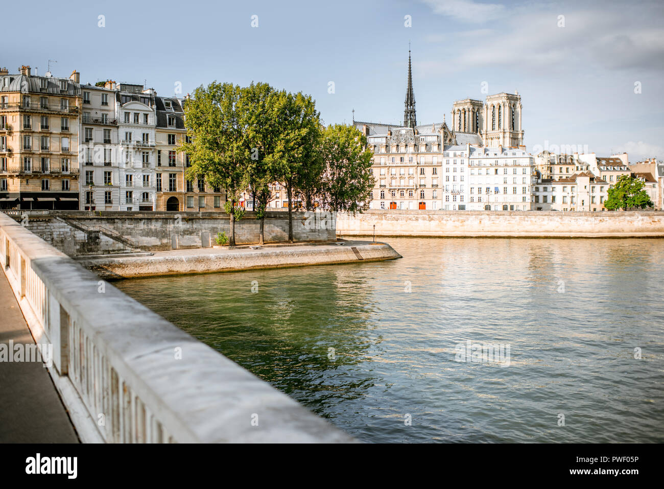 View on the riverside with beautiful buildings and Notre-Dame cathedral ...