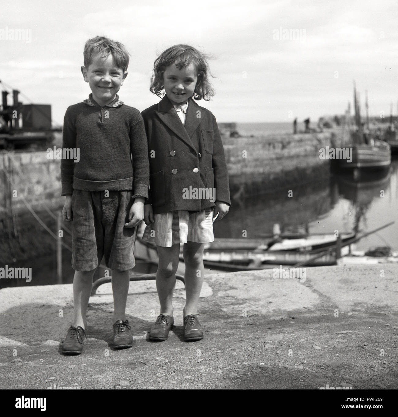 1950s, historical, by a small fishing harbour, a young Irish boy and ...