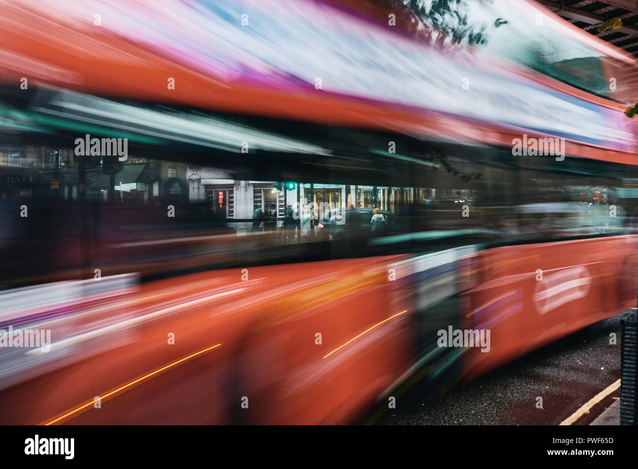 London's double decker red bus drives through town at Camden Market as ...