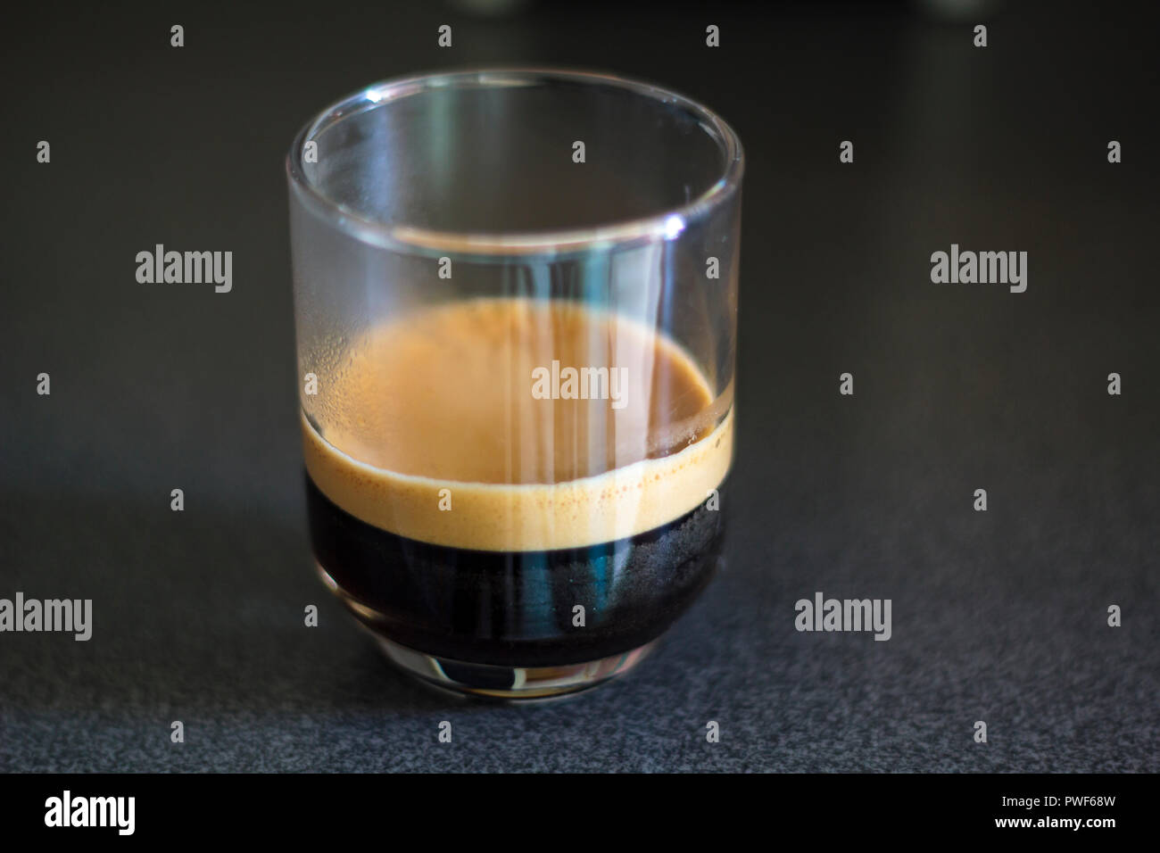 Espresso coffee on a transparent cup Stock Photo - Alamy