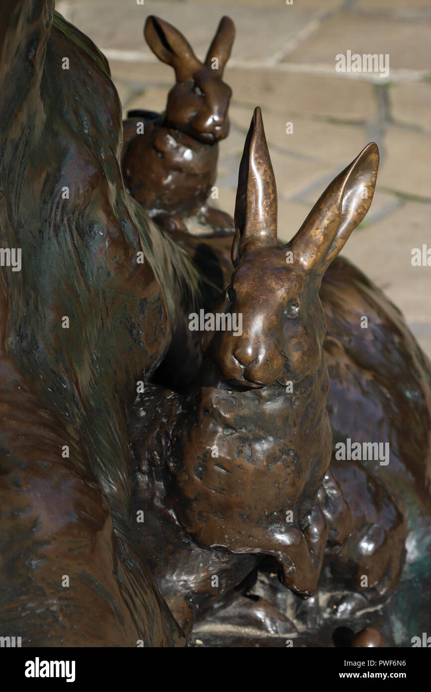 Close up of two charming little rabbits on the bronze statue of Peter ...