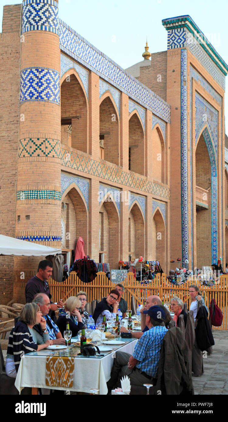 Uzbekistan, Khiva, tourists dining among historic monuments Stock Photo ...