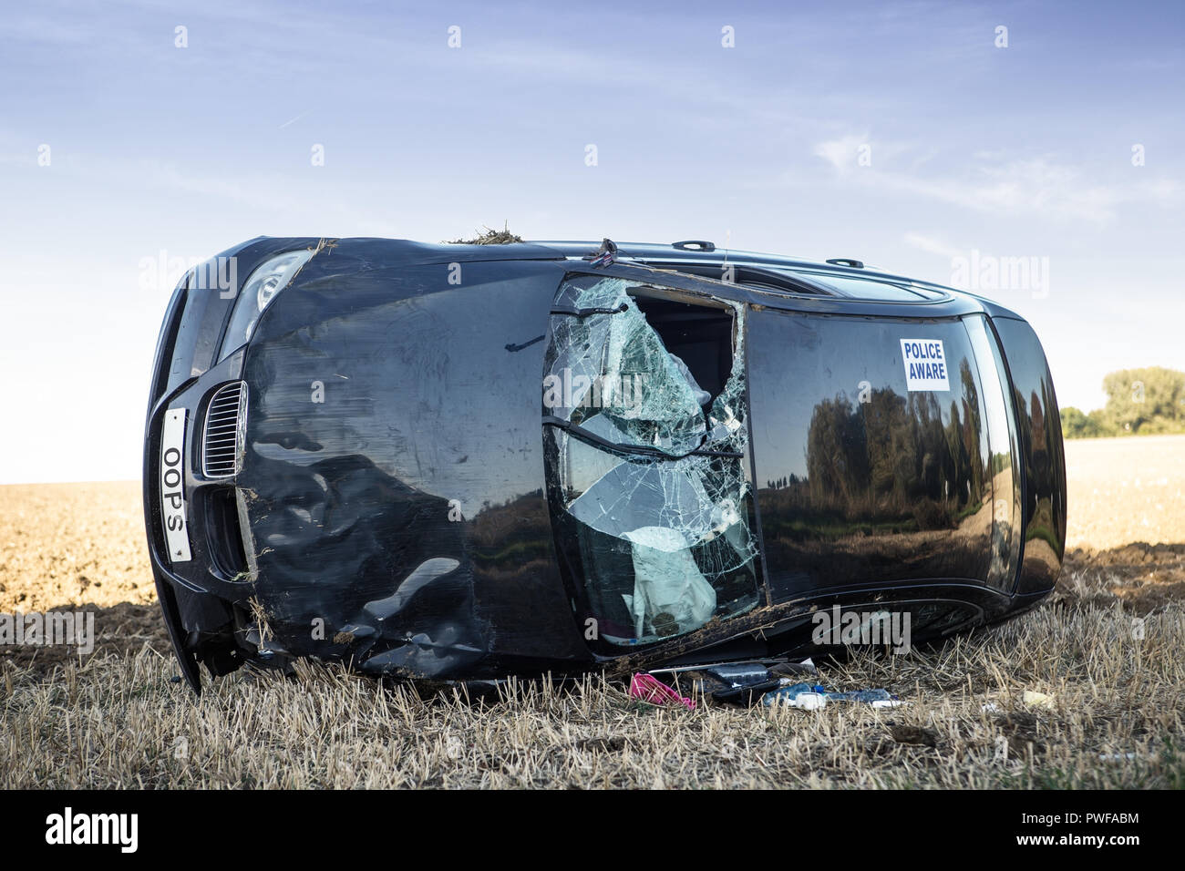 car on its rolled onto its side in a field after going to fast around ...