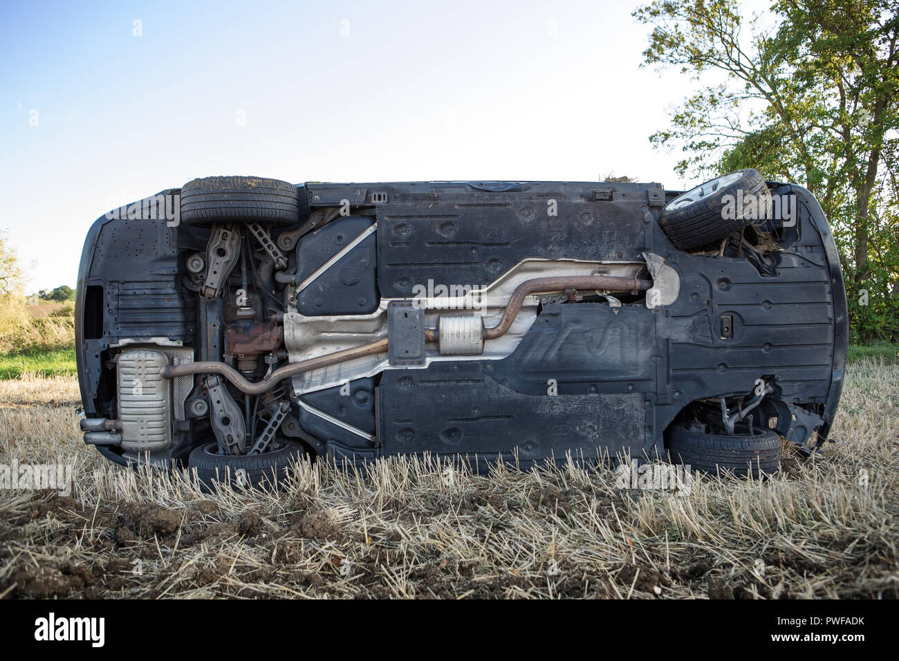 car on its rolled onto its side in a field after going to fast around ...