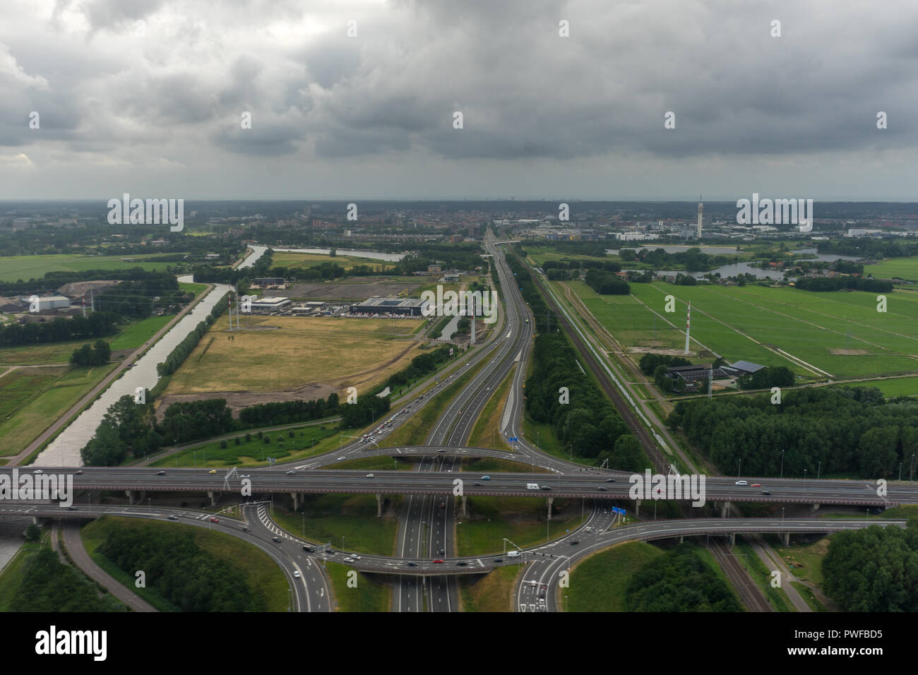 Highway in Holland, Netherlands with canal viewed from plane in sky ...