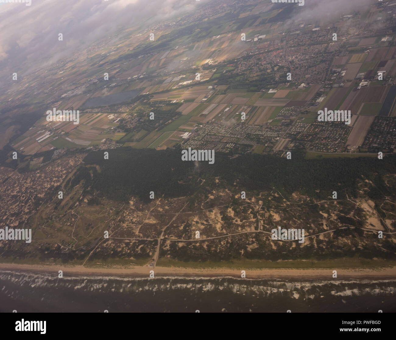 The Netherlands coastline viewed from the sky from a plane window with ...