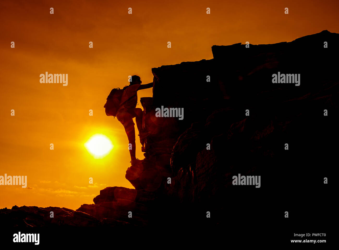 Sporty woman climbing on the cliff. Success and goal concept. Strong ...