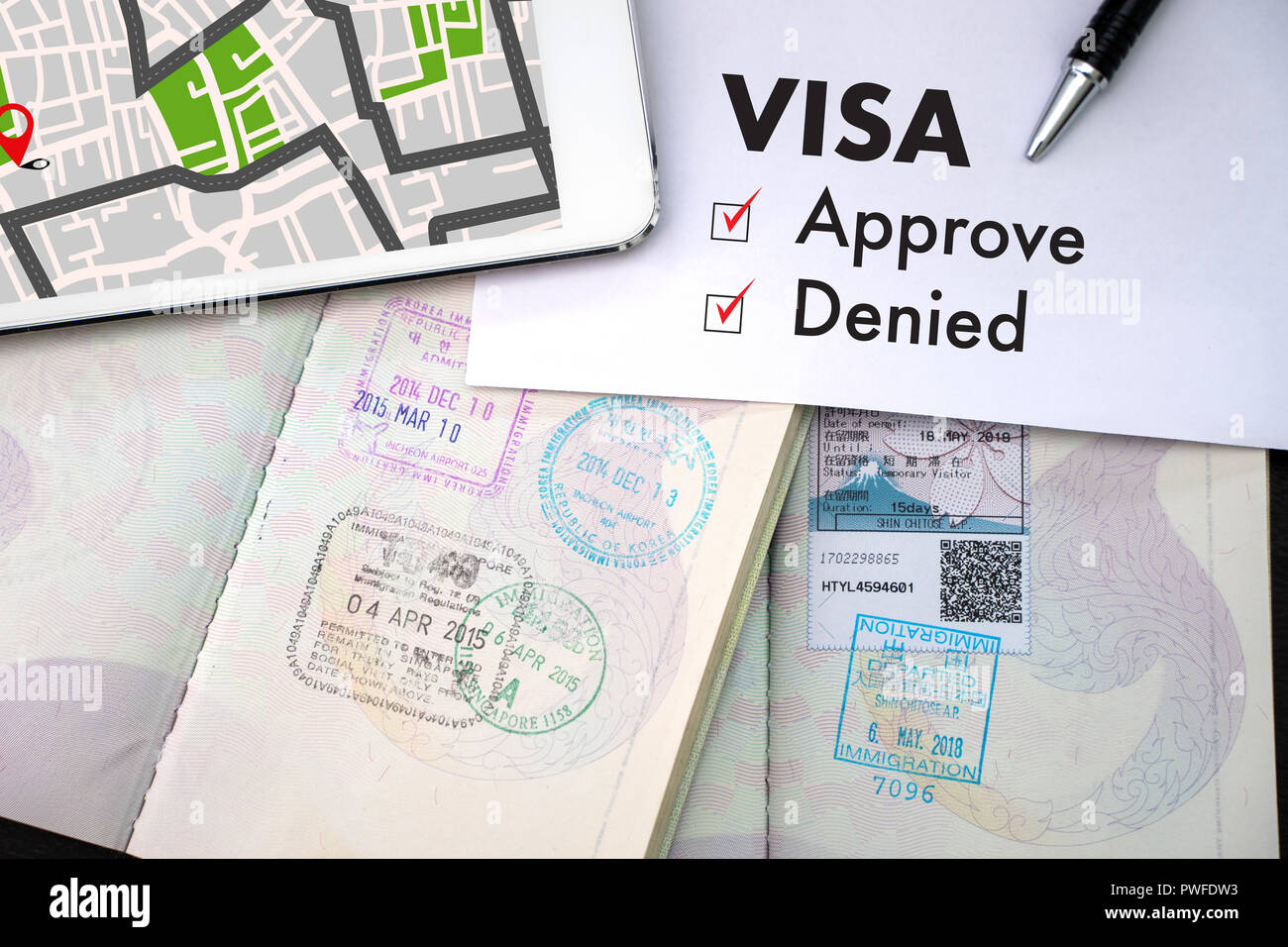 Visa and passport to approved stamped on a document top view in ...