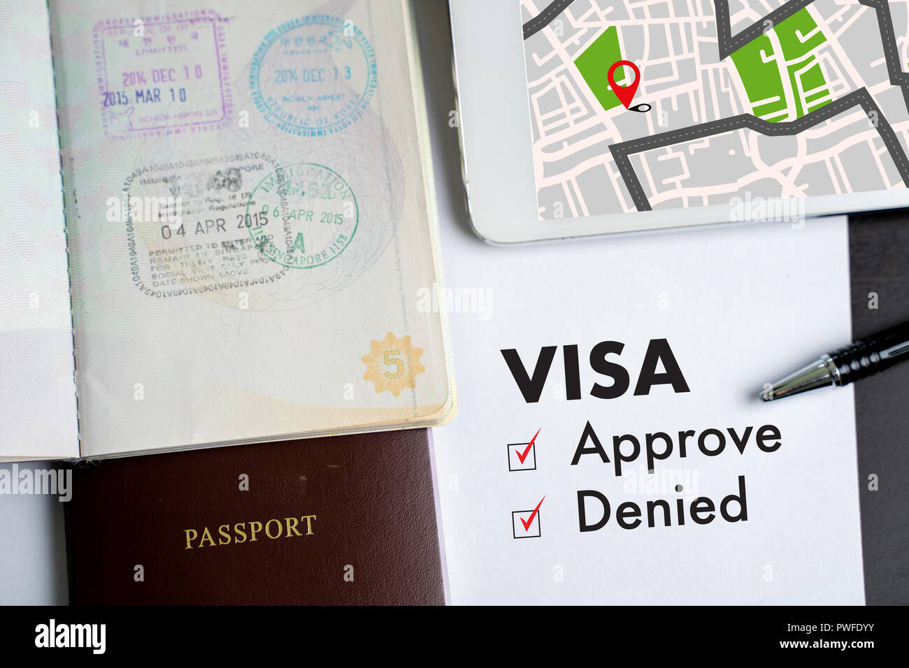 Visa and passport to approved stamped on a document top view in ...