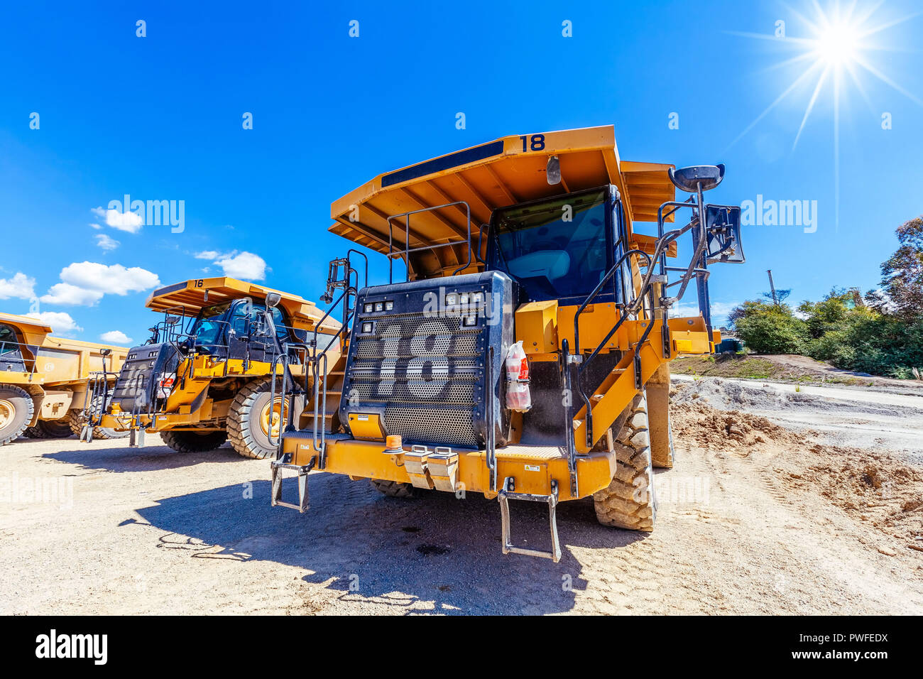 Huge yellow industrial dumper trucks on construction site Stock Photo ...