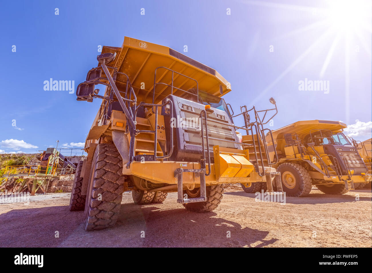 Sun shining on large yellow dumper trucks on a construction site Stock ...
