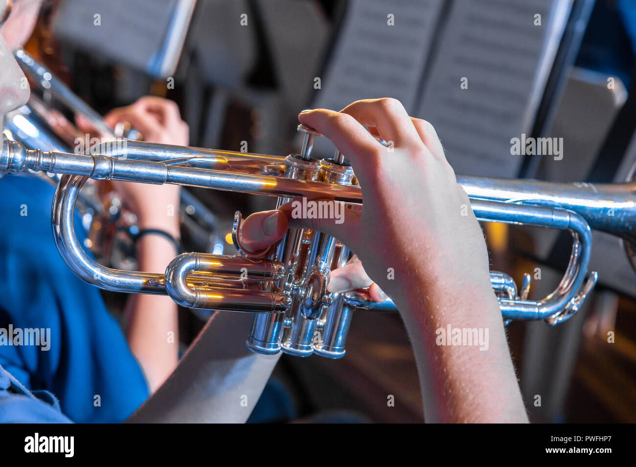 Hand of musician holding trumpet while playing in the band Stock Photo ...