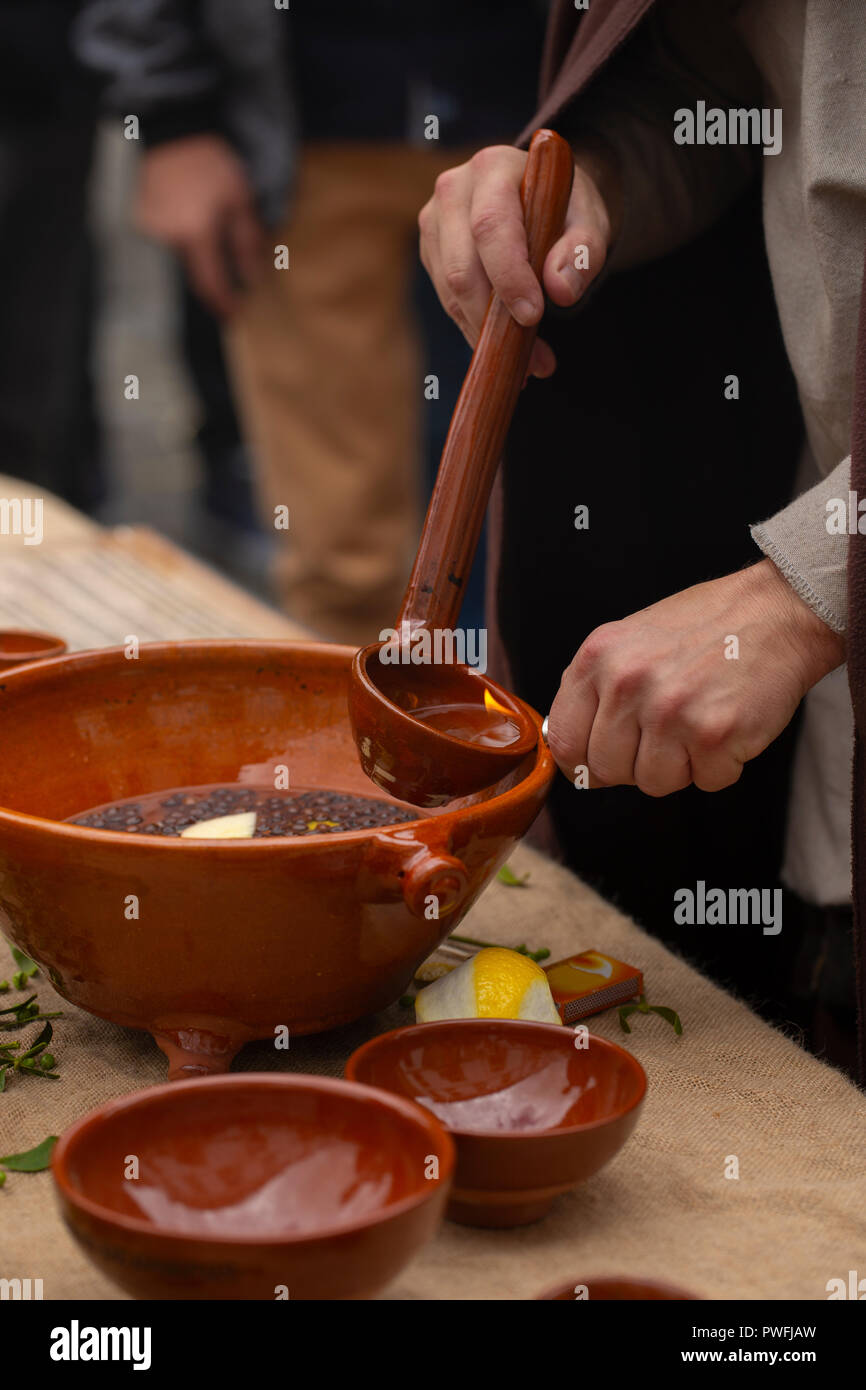A man is preparing queimada (traditional Galician hot drink made with ...