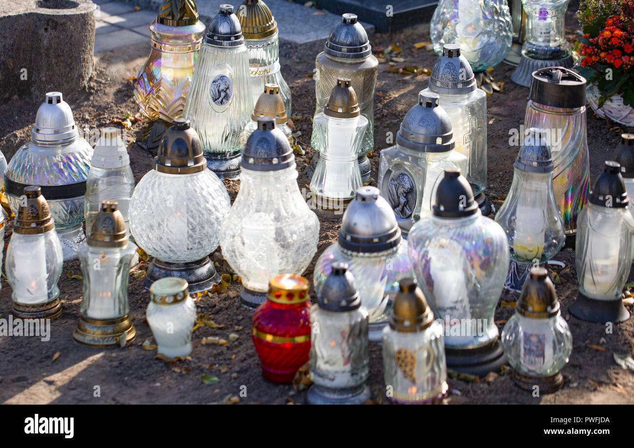 Flowers and candles on a colorful polish cemetery. Autumn, preparations ...