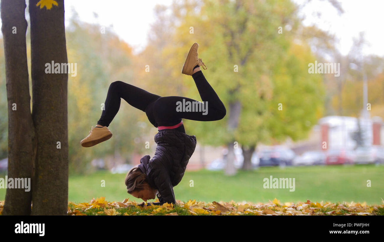 Girl performing gymnast stand on hands in the park Stock Photo - Alamy