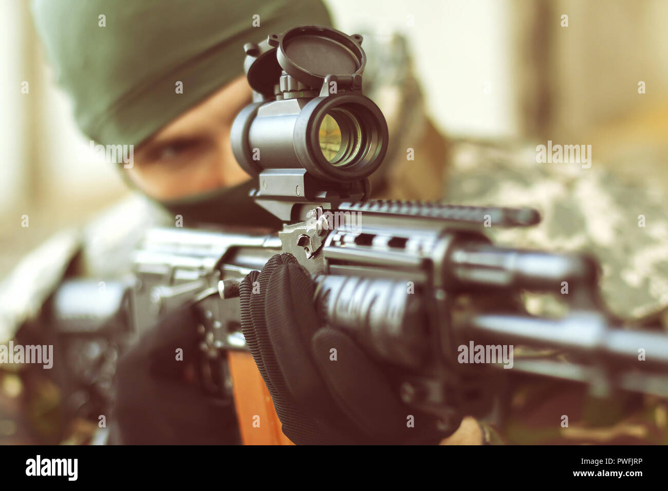 man aiming with an AK-47 with reflex sight Stock Photo - Alamy