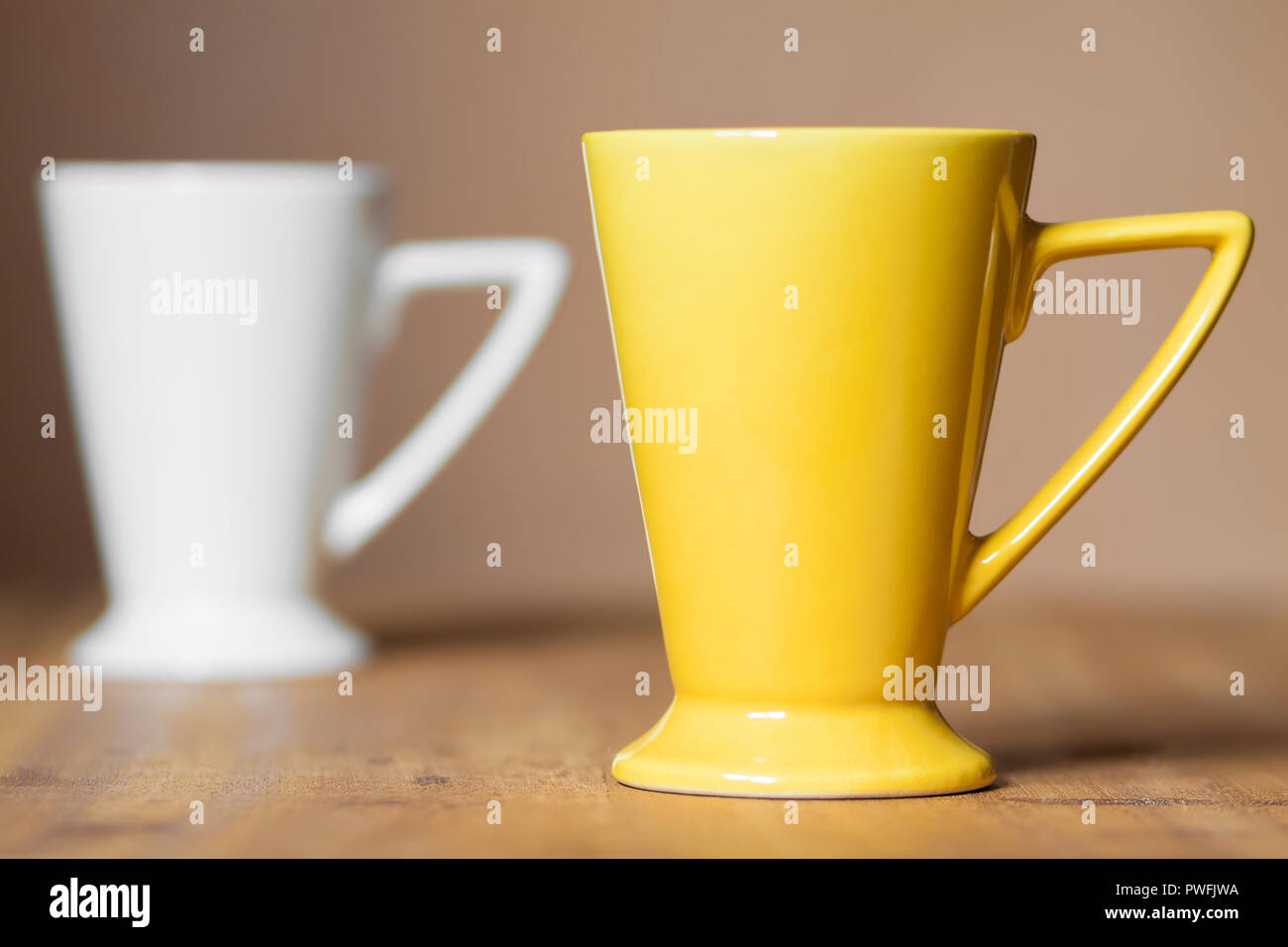 Yellow mug on the wooden table. Office workspace background Stock Photo ...