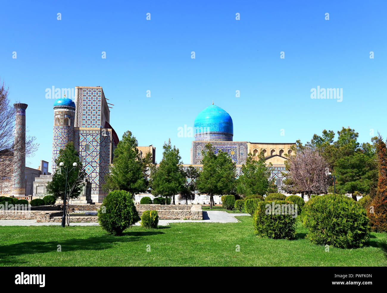 Ensemble of madrasah with pishtaks, painted stone walls and columns of ...