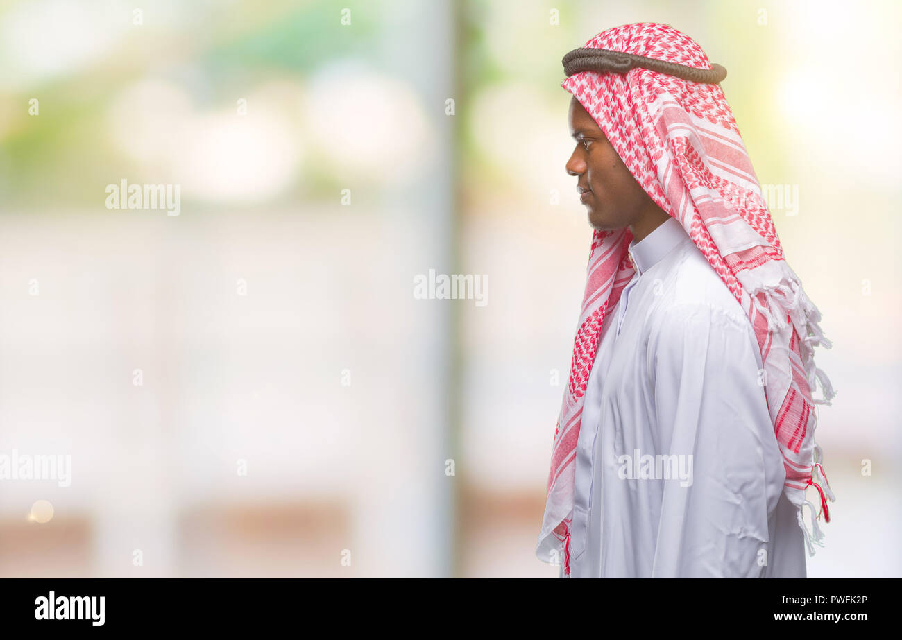 Young arabic african man wearing traditional keffiyeh over isolated ...