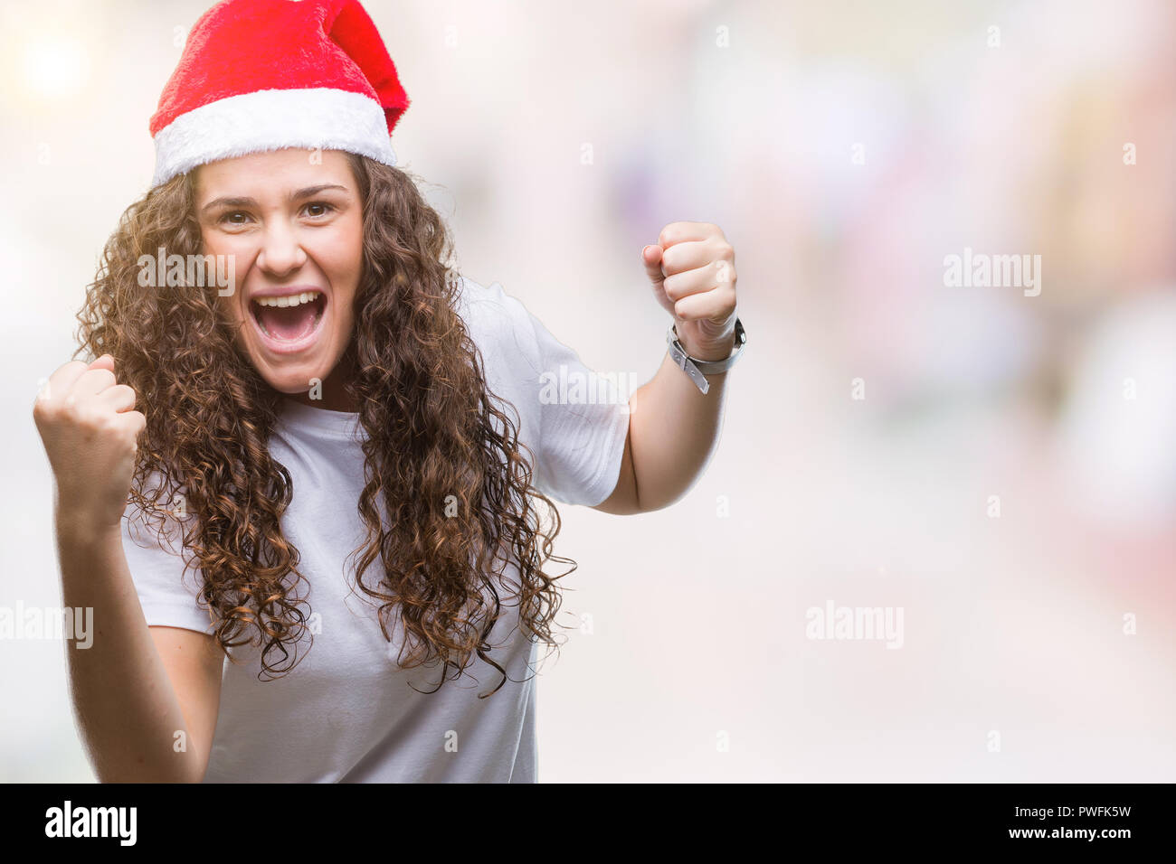Young brunette girl wearing christmas hat over isolated background very ...