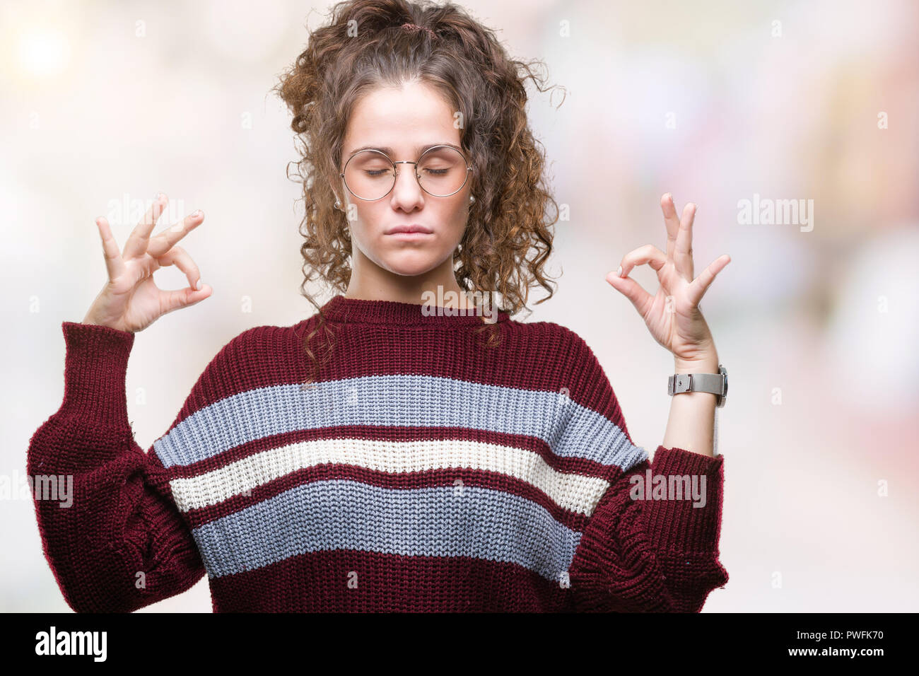 Beautiful brunette curly hair young girl wearing glasses over isolated ...