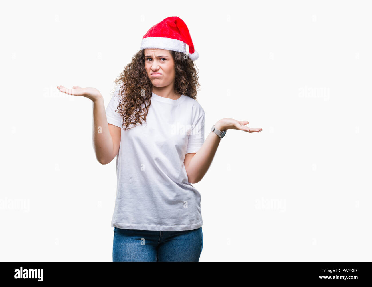 Young brunette girl wearing christmas hat over isolated background ...