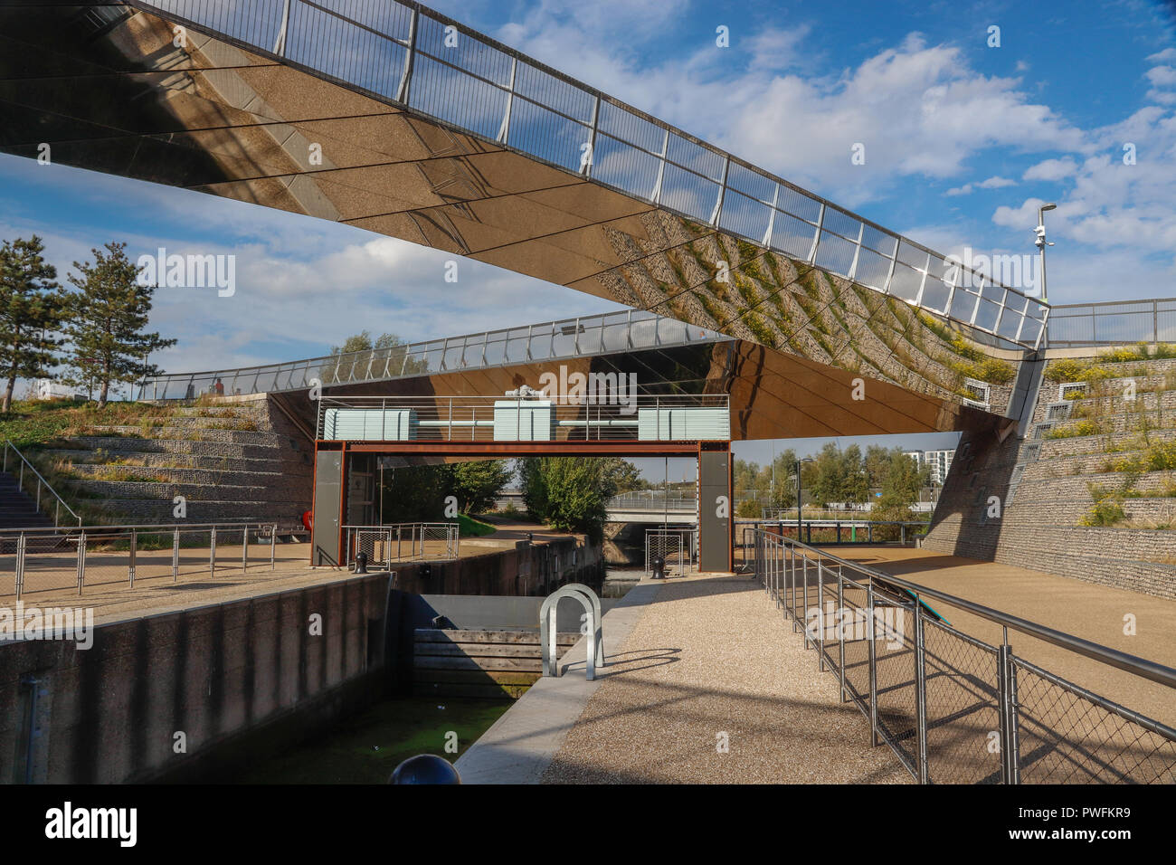 The reflective Diamond Bridge and Carpenters Lock on the River Lea in ...