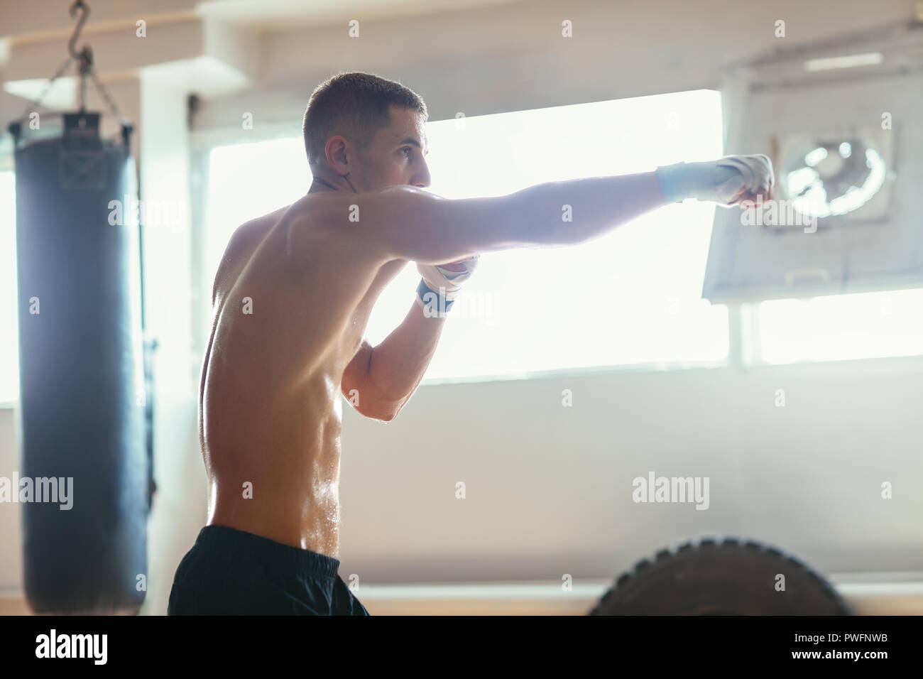 Male boxer during boxing exercise making direct hit. sport concept ...