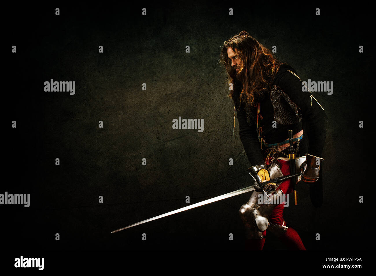 Portrait of a knight in armor, long hair Stock Photo - Alamy
