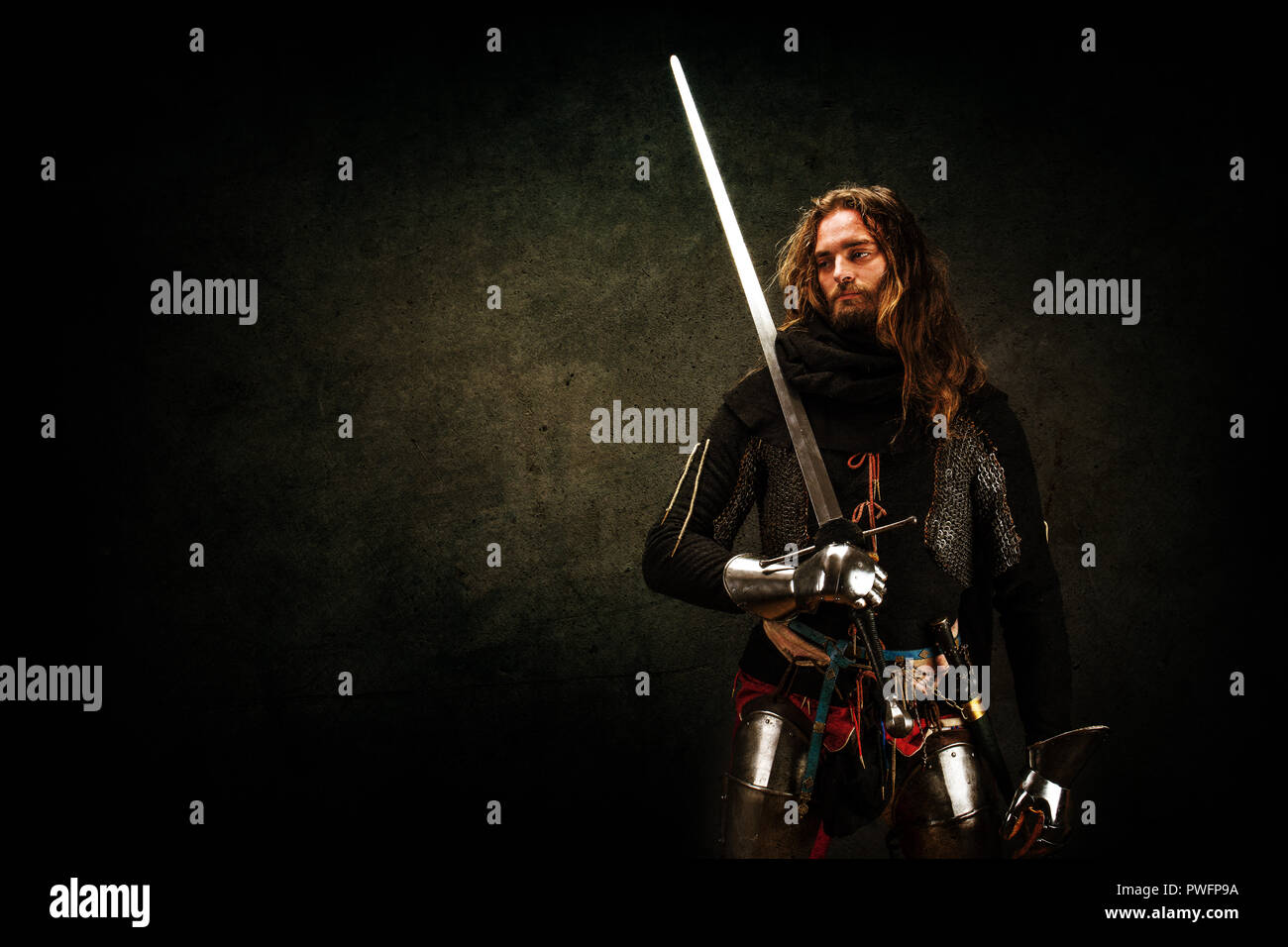 Portrait of a knight in armor, long hair Stock Photo - Alamy