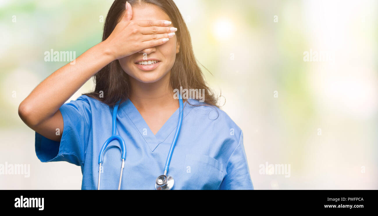 Young arab doctor surgeon woman over isolated background smiling and ...