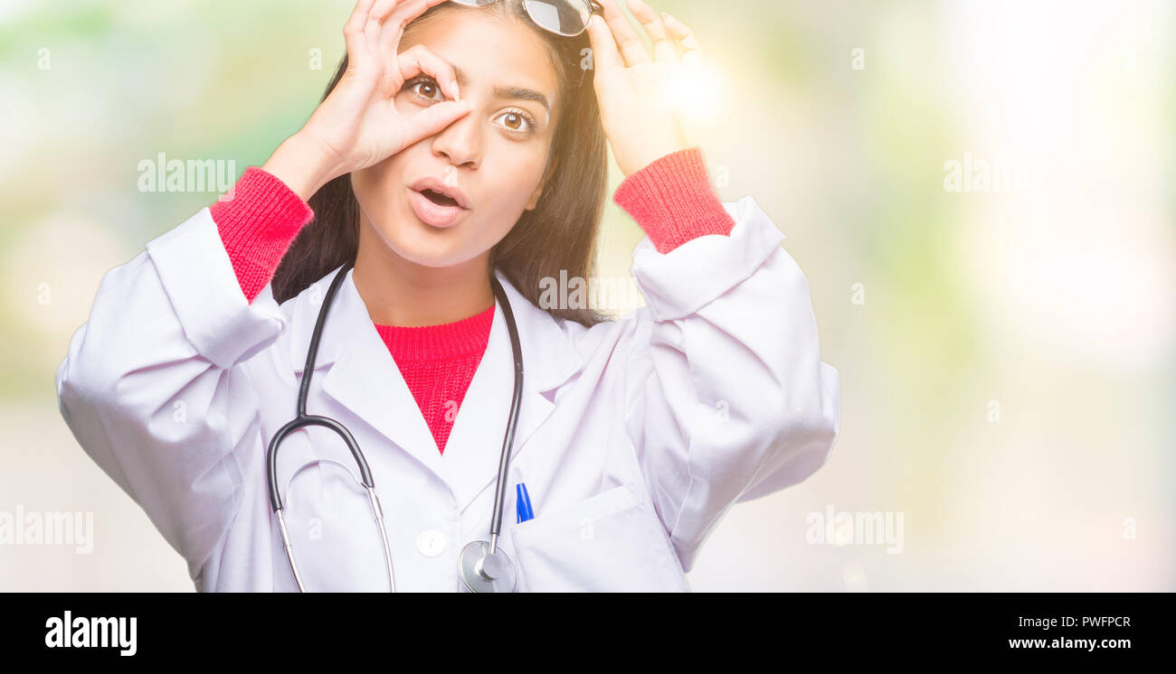 Young arab doctor woman over isolated background doing ok gesture ...