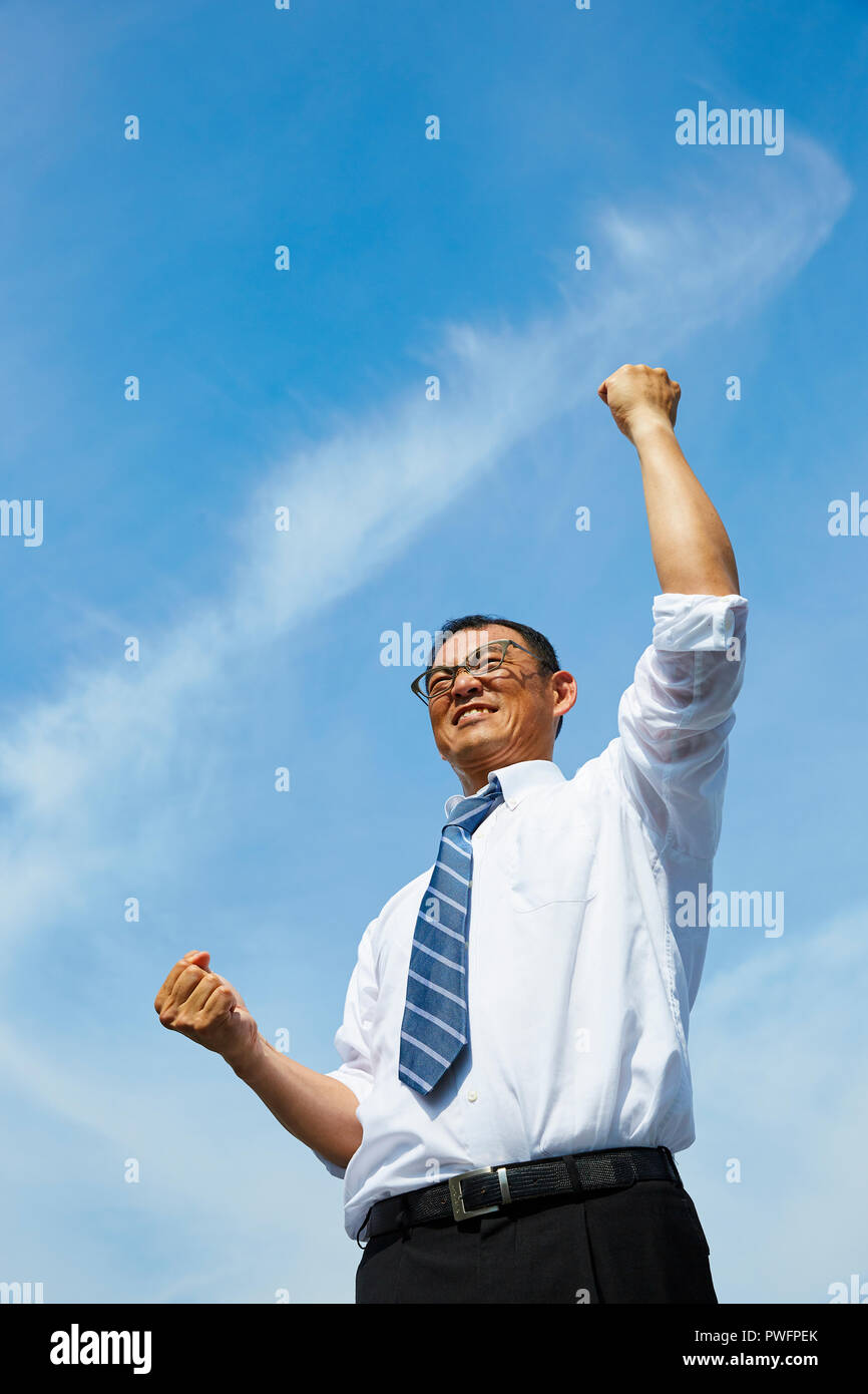 Japanese salaryman against blue sky Stock Photo - Alamy