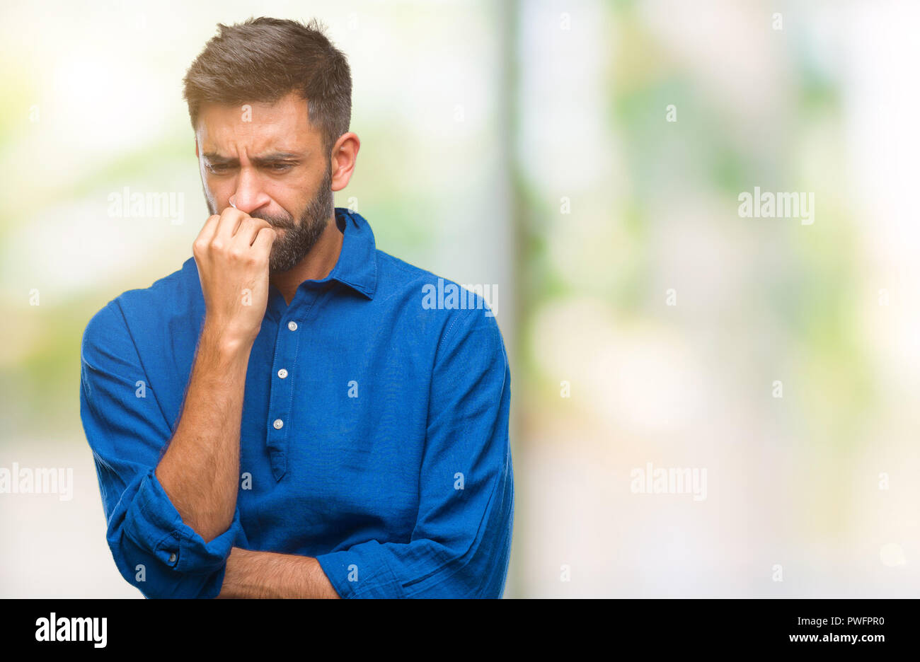 Adult hispanic man over isolated background looking stressed and ...
