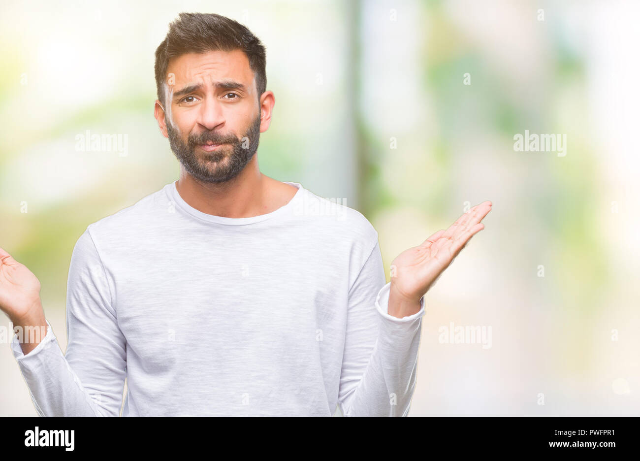 Adult hispanic man over isolated background clueless and confused ...