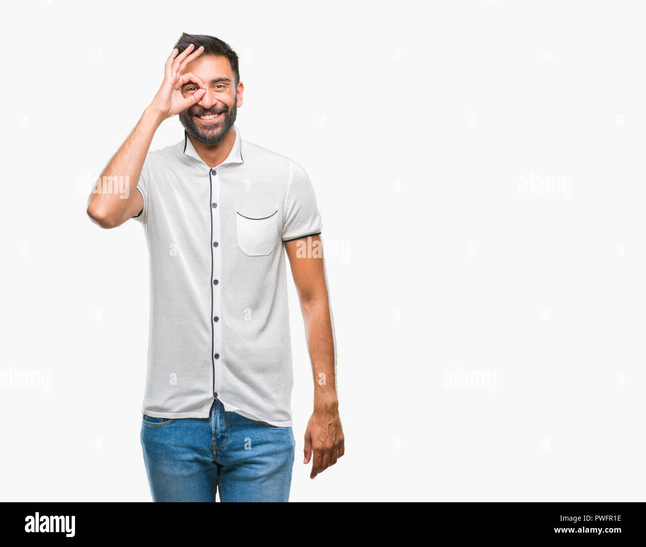 Adult hispanic man over isolated background doing ok gesture with hand ...