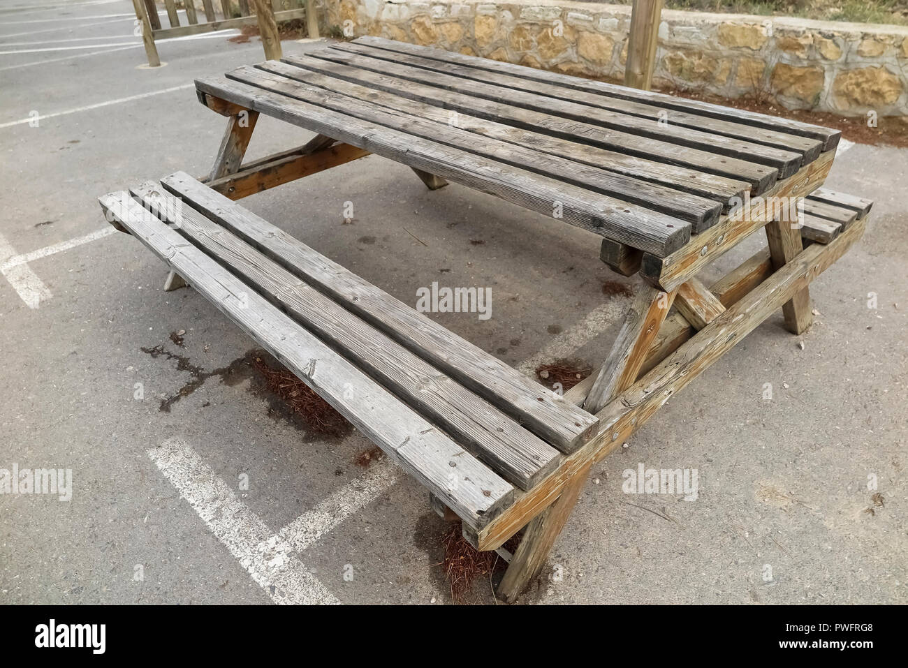 foreground view from above of a empty wooden bench on a picnic area in ...