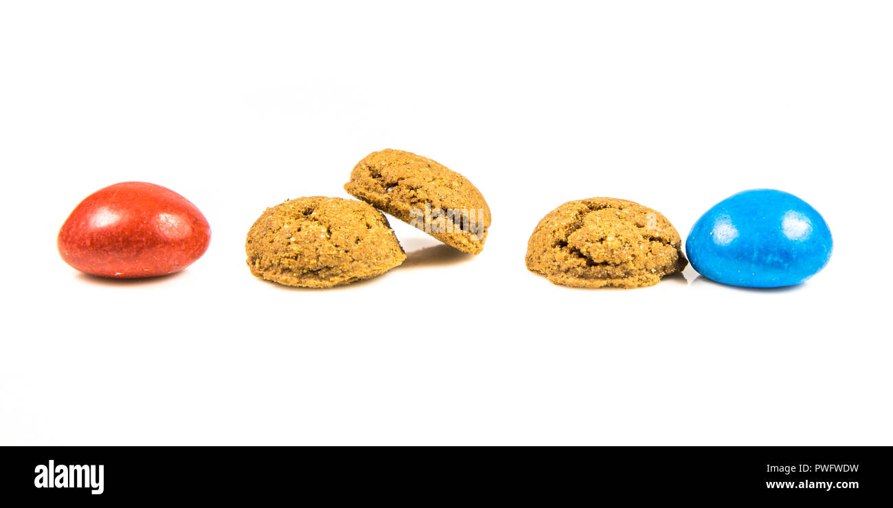 Row of colorful Pepernoten traditional dutch treats on white background ...