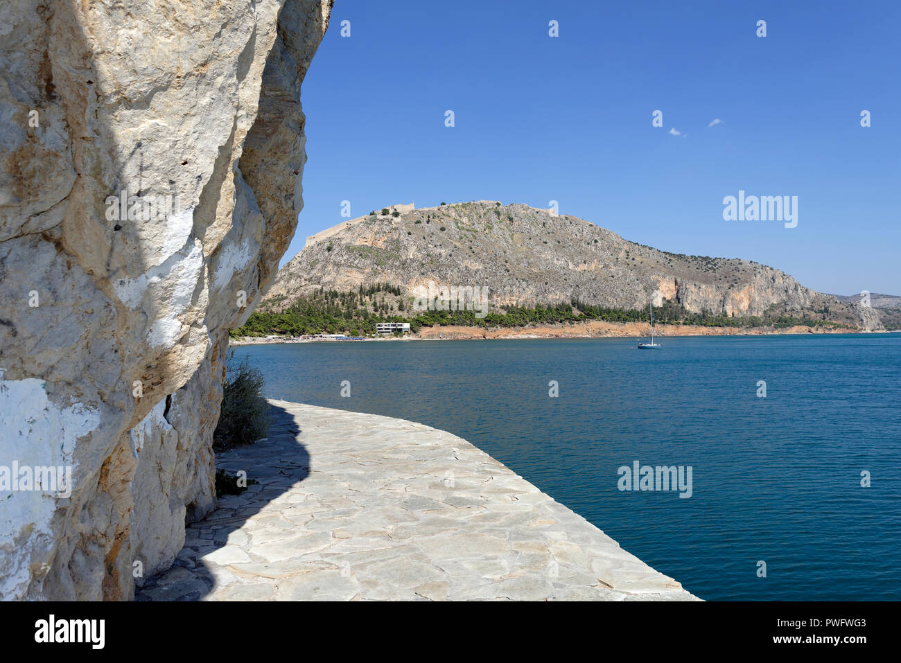 View of the small pebble Arvanitia Beach and the Fortress of Palamidi ...