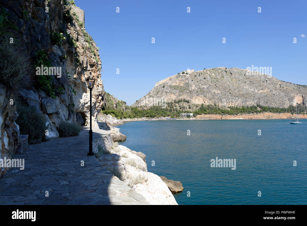 View of the small pebble Arvanitia Beach and the Fortress of Palamidi ...