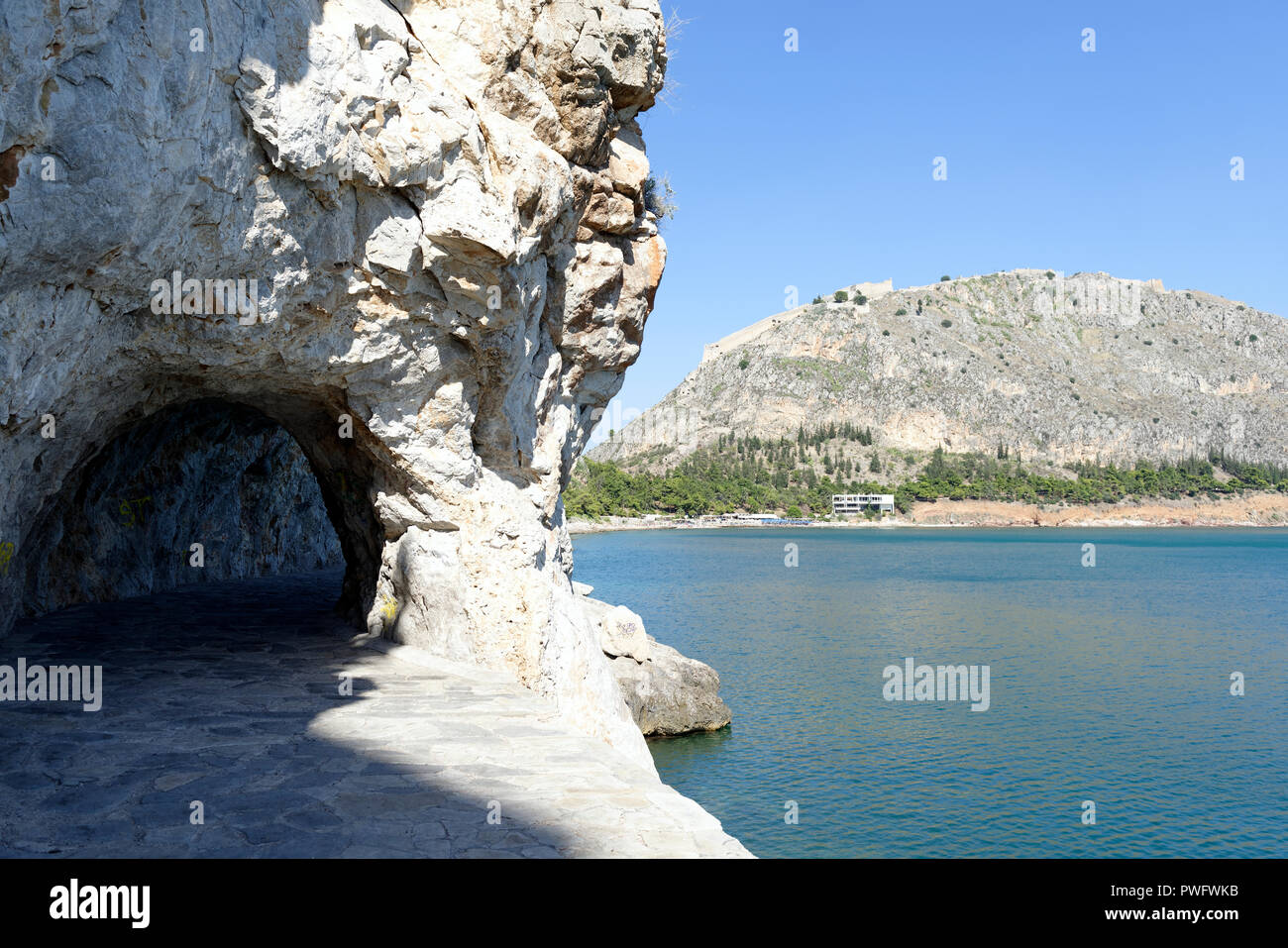View of the small pebble Arvanitia Beach and the Fortress of Palamidi ...