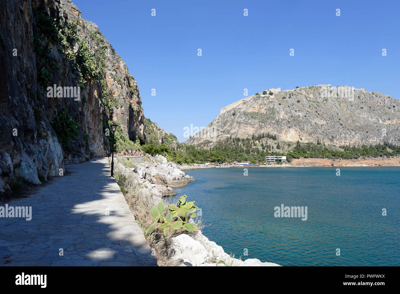 View of the small pebble Arvanitia Beach and the Fortress of Palamidi ...