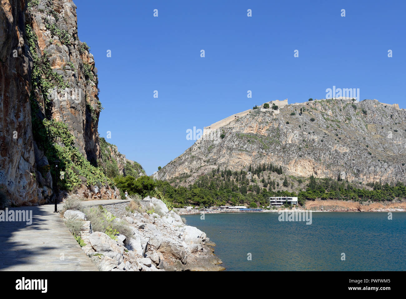 View of the small pebble Arvanitia Beach and the Fortress of Palamidi ...
