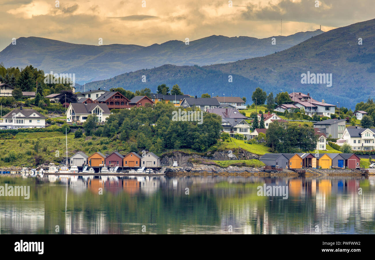 Scenic village on the coastline of fjord with colorful boathouses near ...